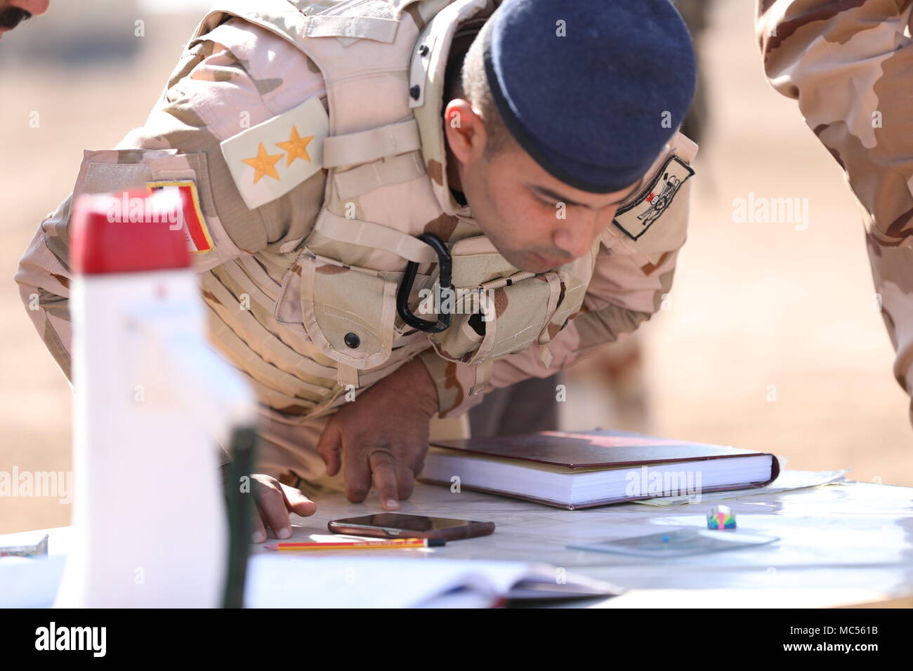 An Iraqi army officer prepares a live fire mission with a M198 155 mm ...