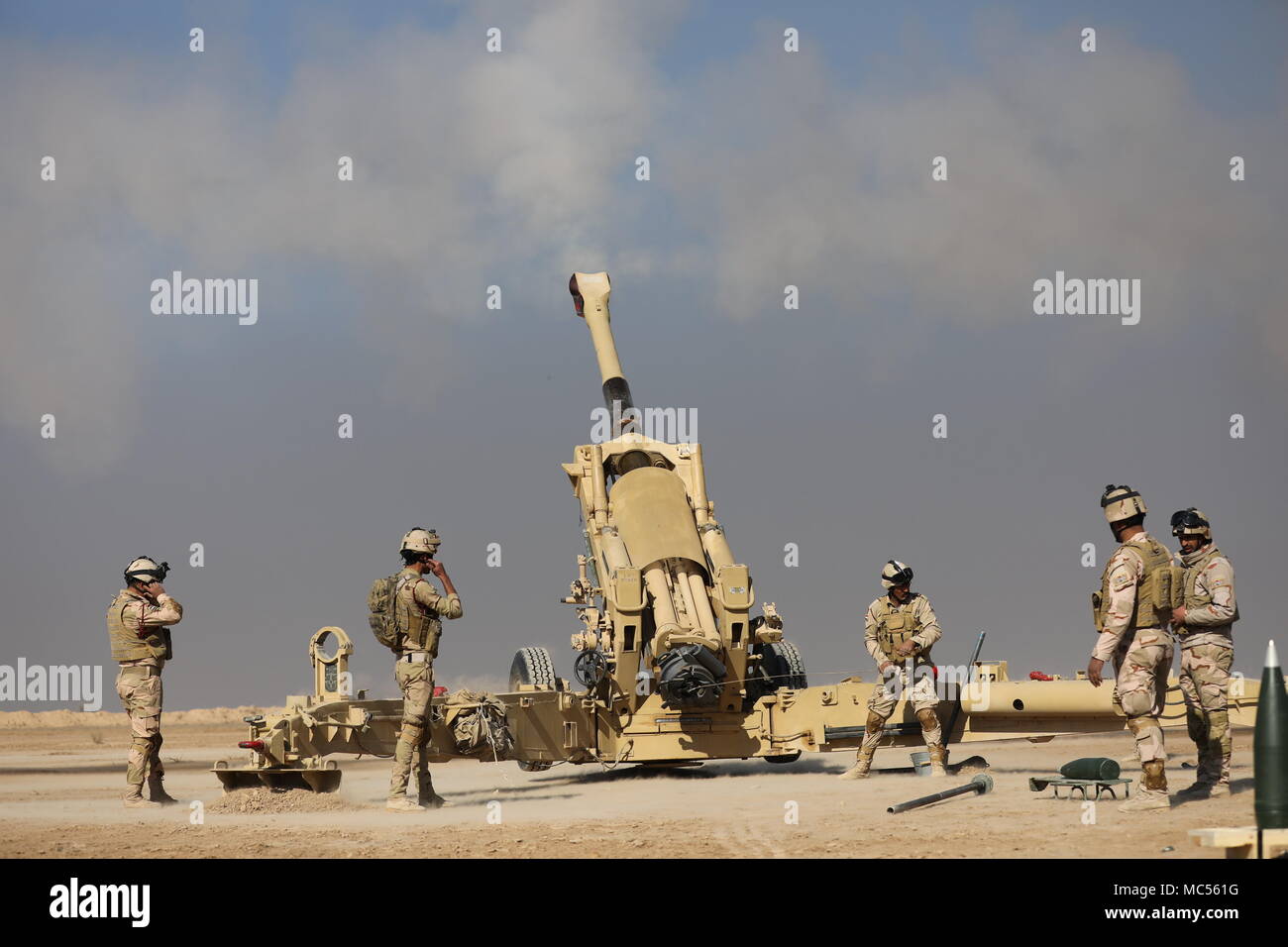 Iraqi army soldiers load a M198 155 mm howitzer while being trained by French forces at the ...