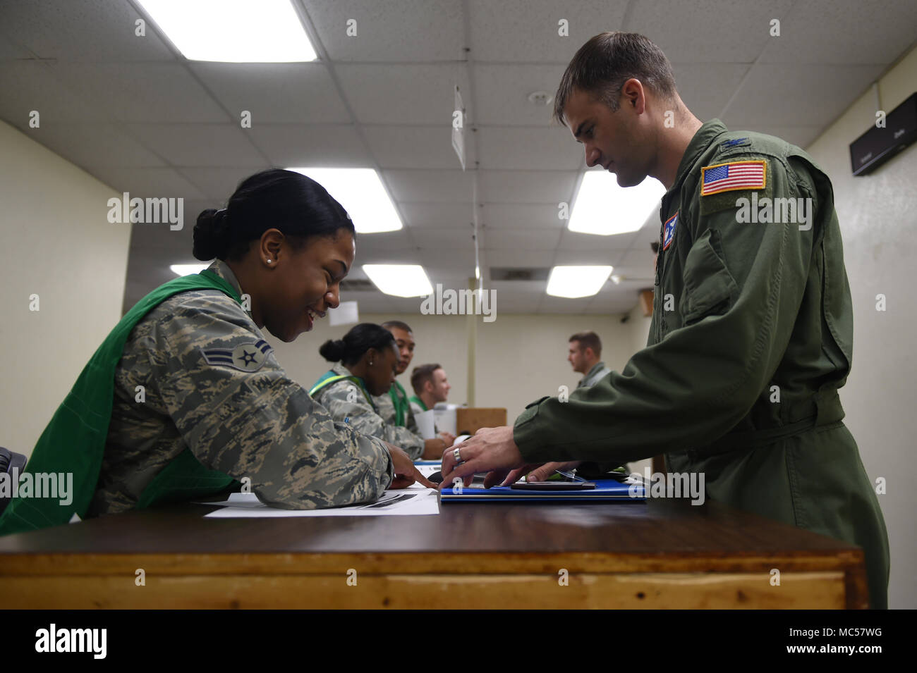 U.S. Air Force Col. James Hackbarth, 317th Operations Group commander, right, is processed by ...