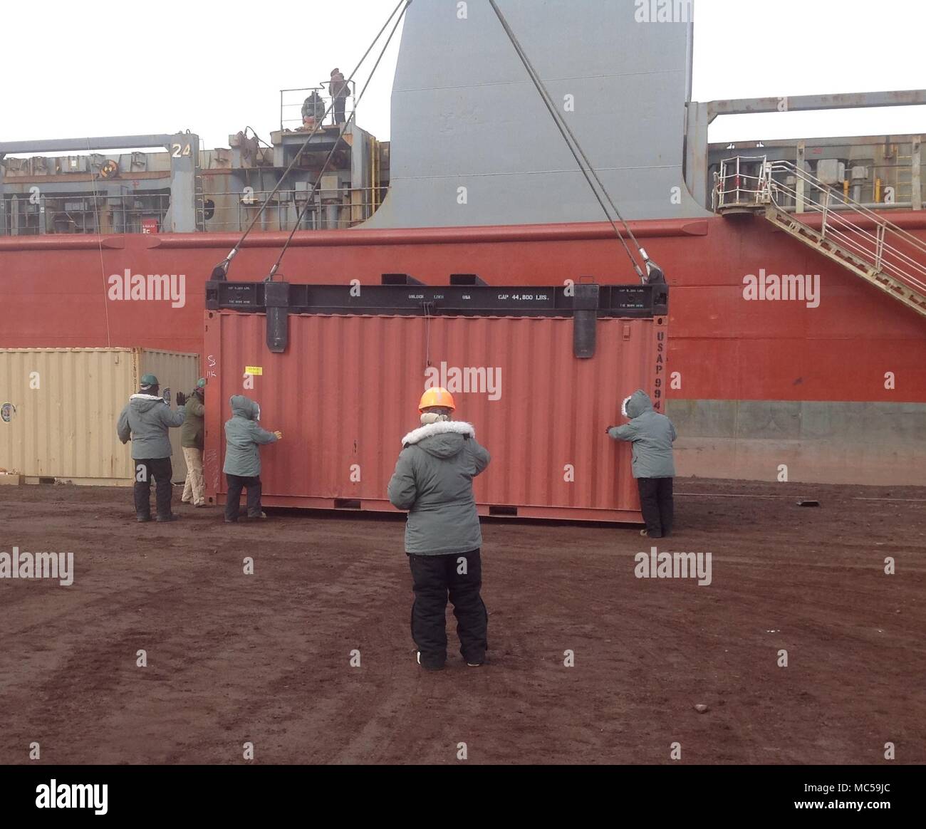 Members of the Navy Cargo Handling Battalion ONE work to offload the ...