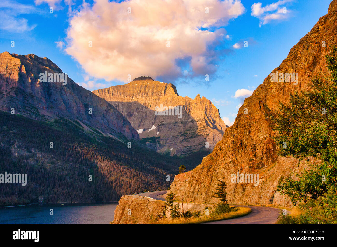 Sunrise lighting the mountains along Going to the Sun Road in Glacier ...