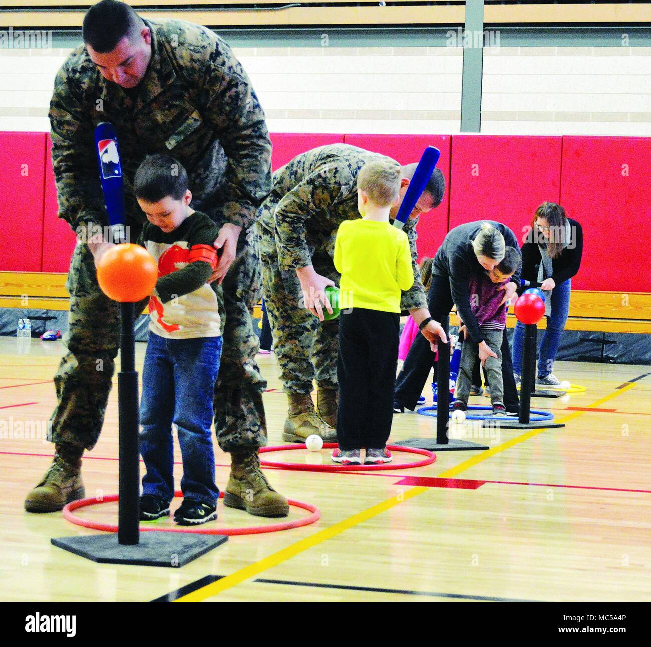 A father helps his son with his swing. (Photo by Jeremy Beale Stock ...