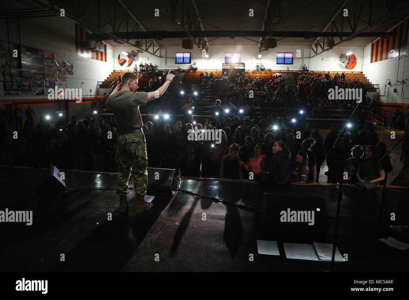 Students from Stover High School in Stover, MO raise their phones up ...