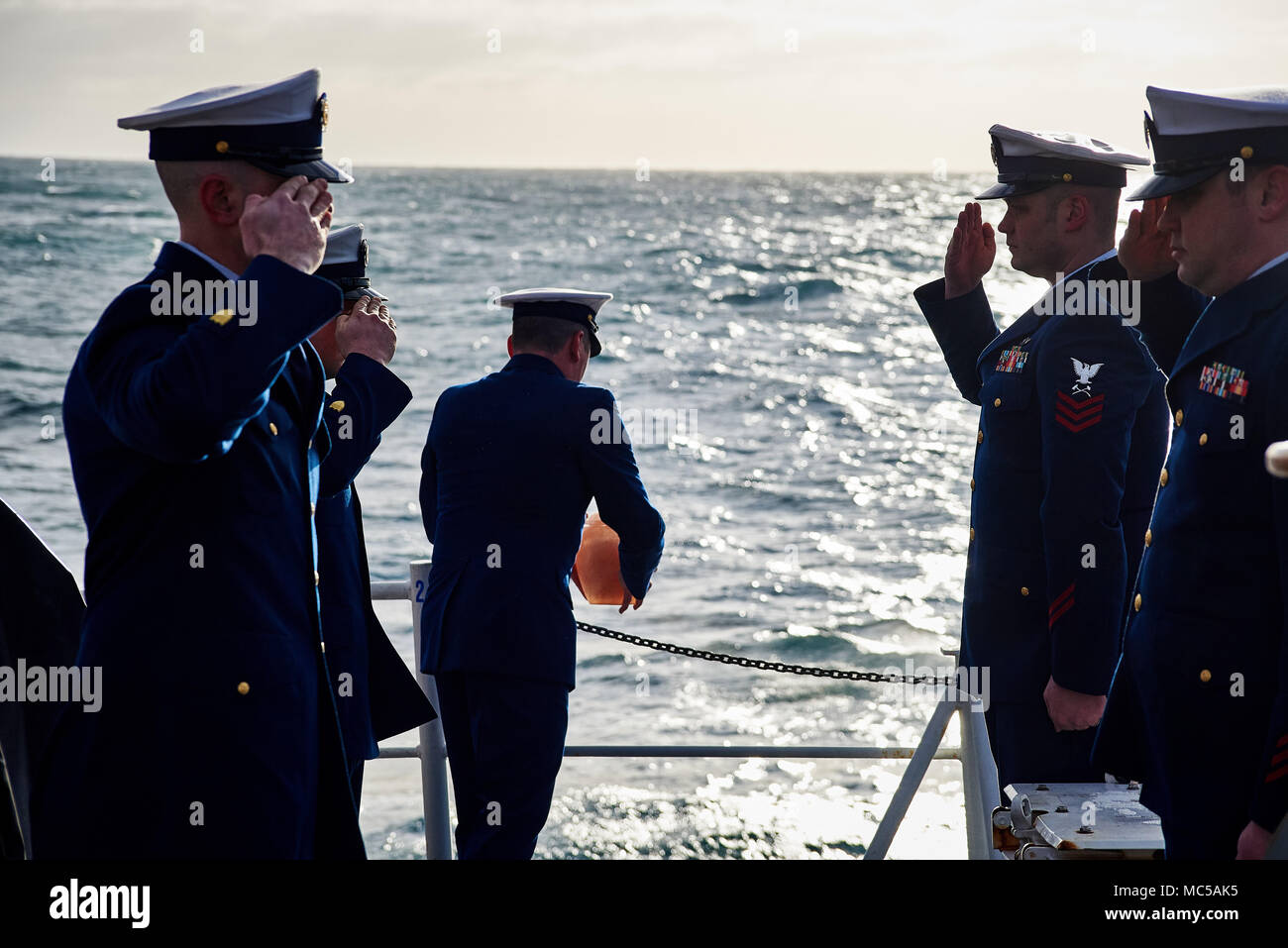 Members aboard the Coast Guard Cutter SPAR conduct a burial at sea near ...