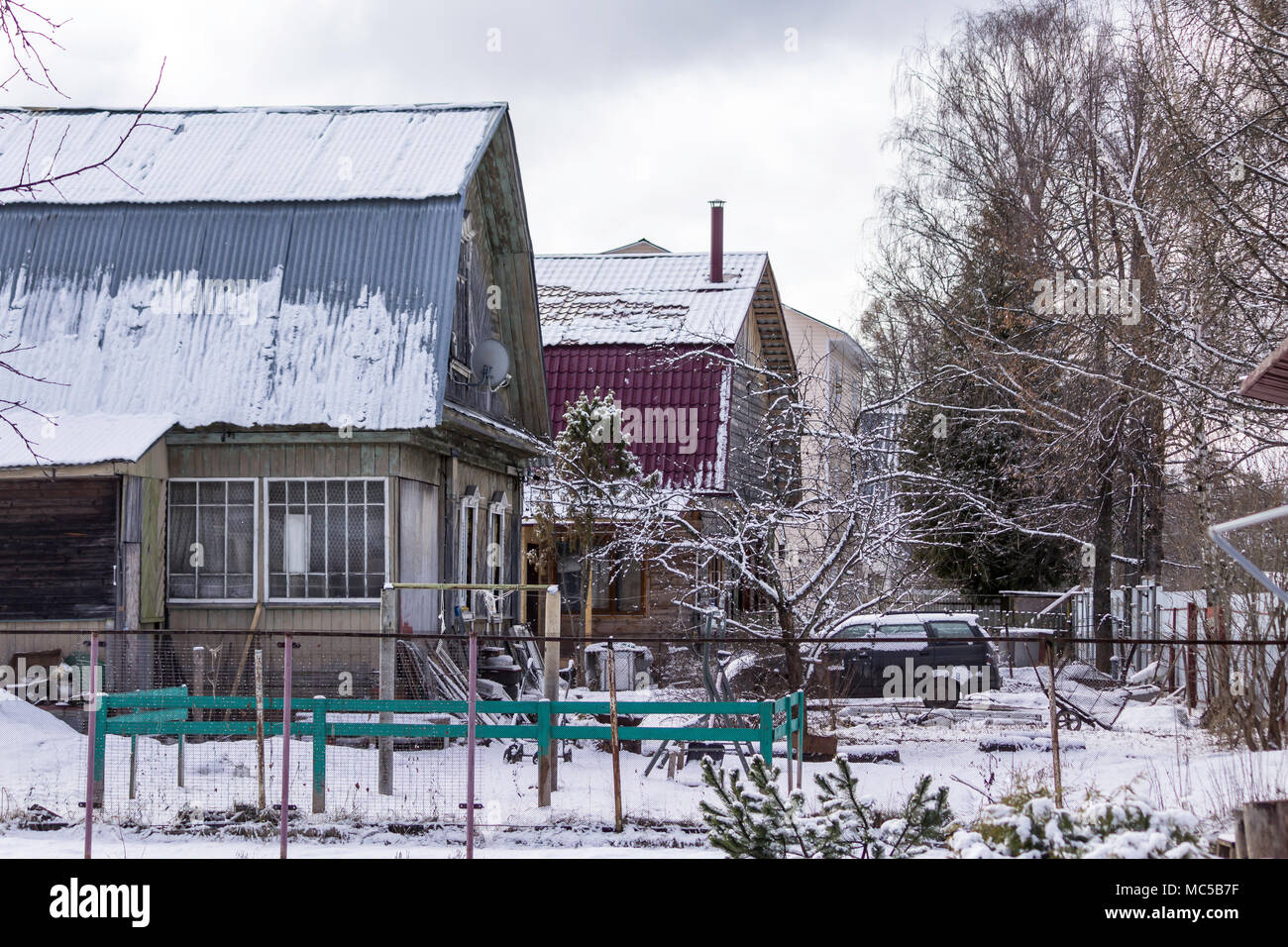 Spring on the street suburban village. At night, snow fell and begins ...