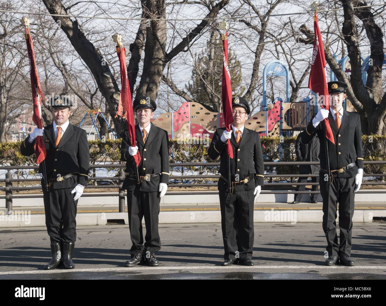 Misawa City fire department volunteers post flags during the Annual ...