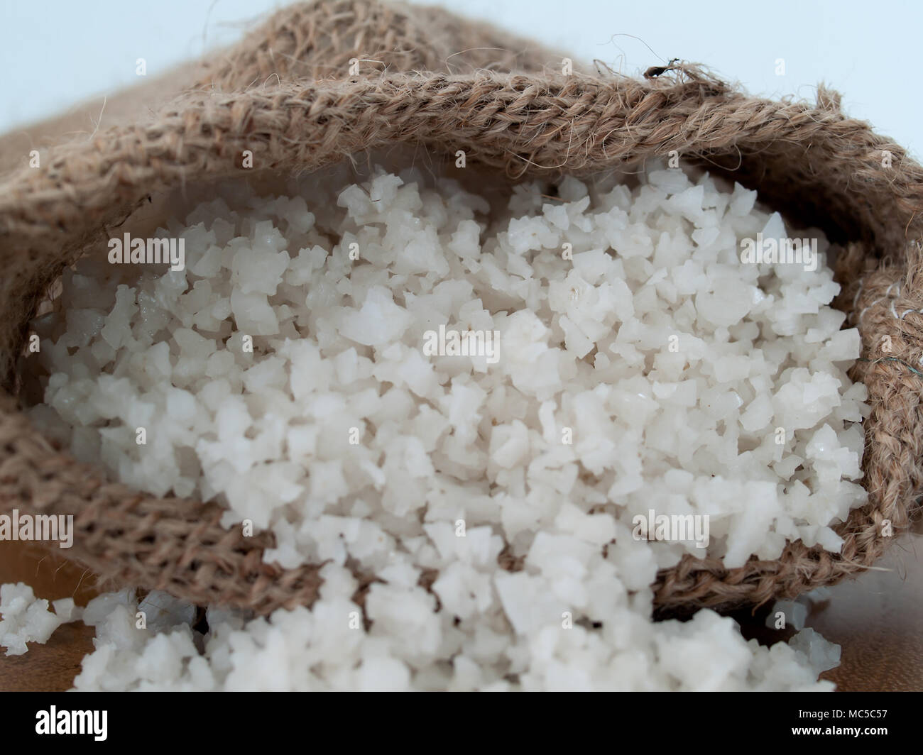 Sea salt or sea salt, put in a sack and put on the wooden floor Stock ...