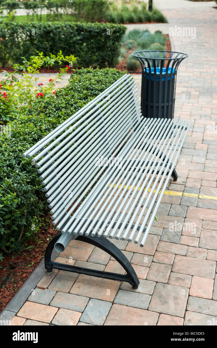 stylish bench and metal trash can Stock Photo - Alamy