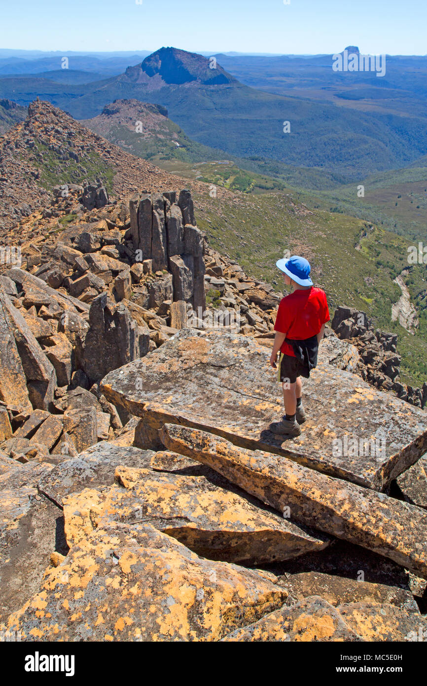 Boy on the summit of Mt Ossa, Tasmania's highest mountain, looking out ...