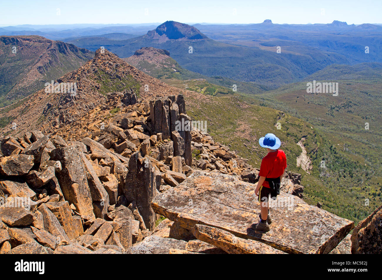 Boy on the summit of Mt Ossa, Tasmania's highest mountain, looking out ...
