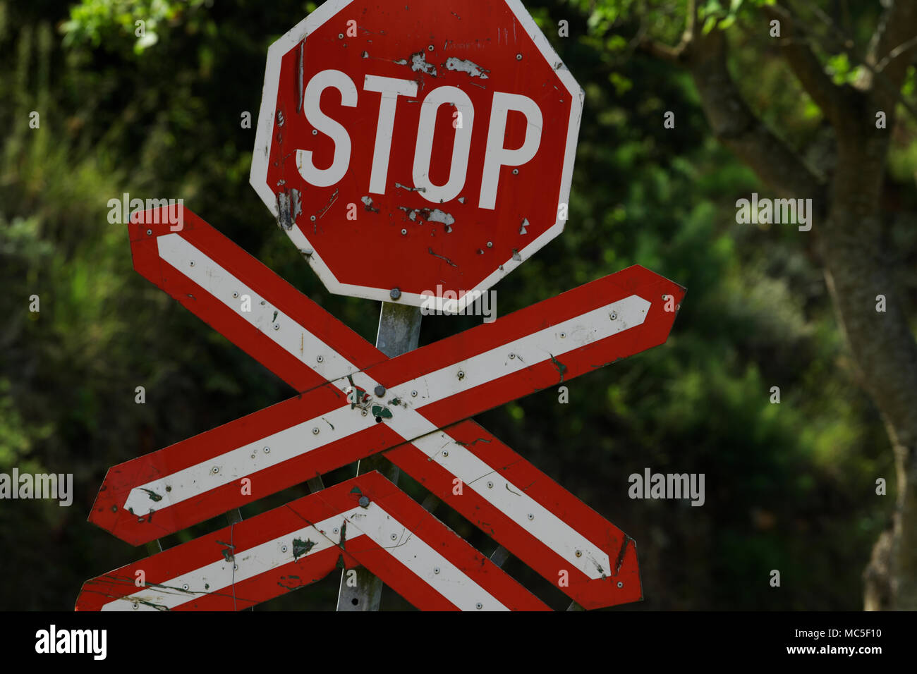 Stop sign at railway crossing severely damaged by vandalism Stock Photo ...