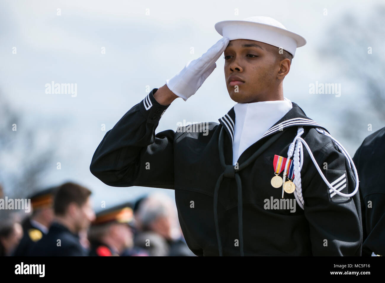 A Sailor from The U.S. Navy Ceremonial Guard renders honors during the full honors funeral of U ...