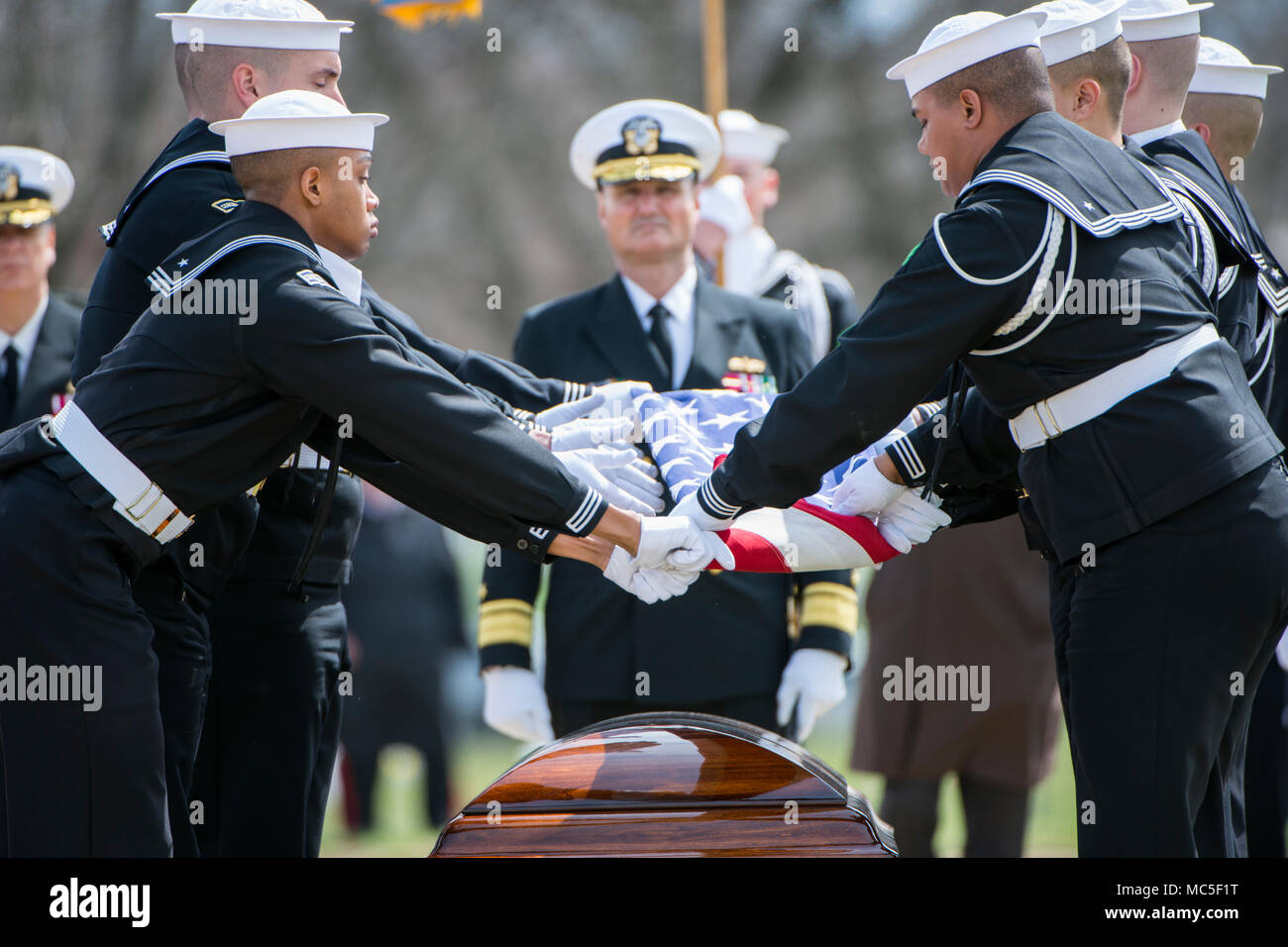 Sailors from The U.S. Navy Ceremonial Guard fold the American flag ...