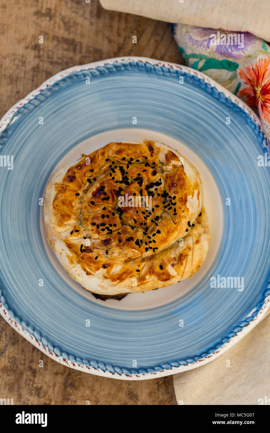 upper view shot of turkish pastry in blue ceramic plates on white ...