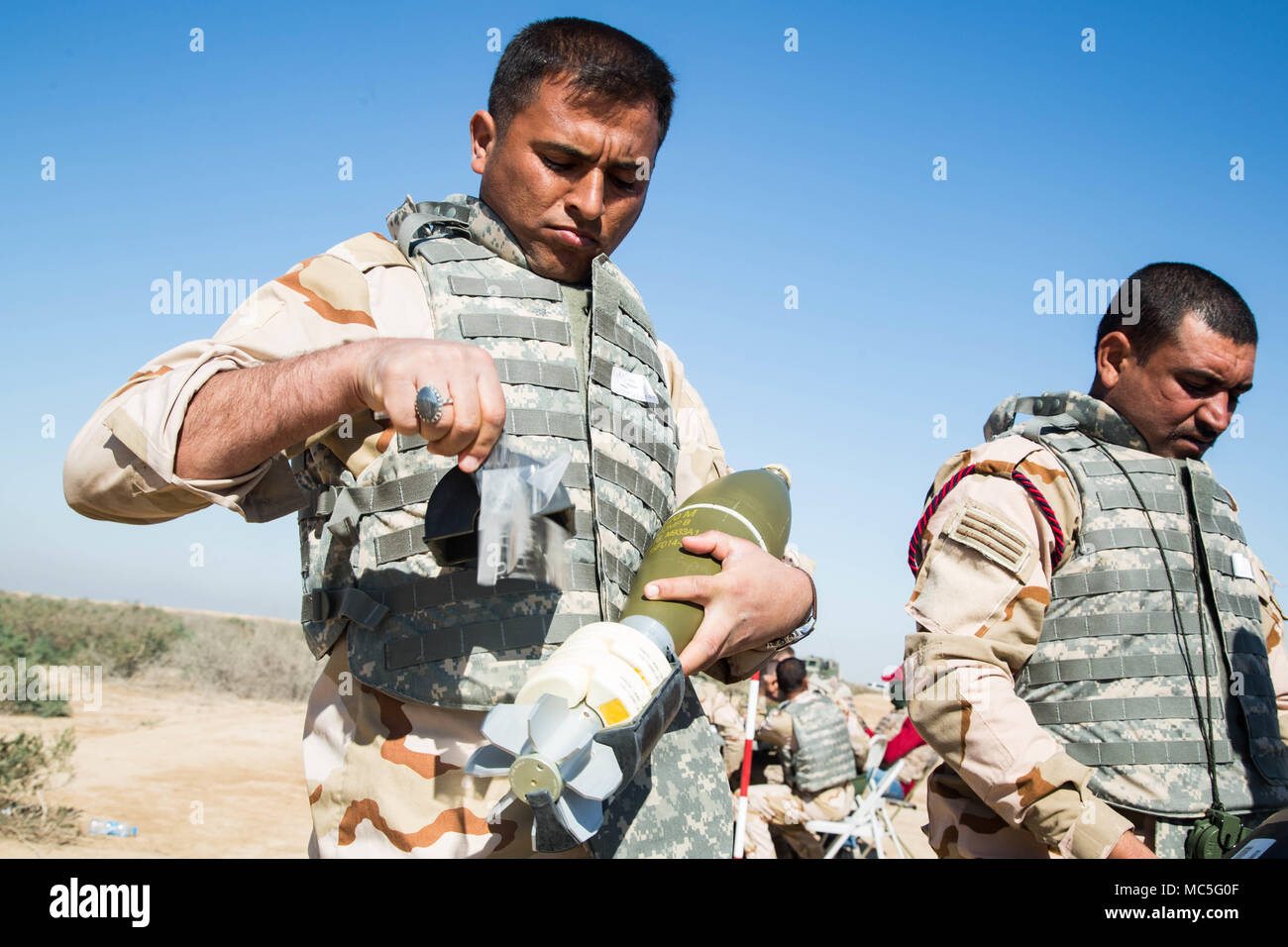 Iraqi soldiers from the 40th Brigade, prepare ammunition for the 120 mm ...