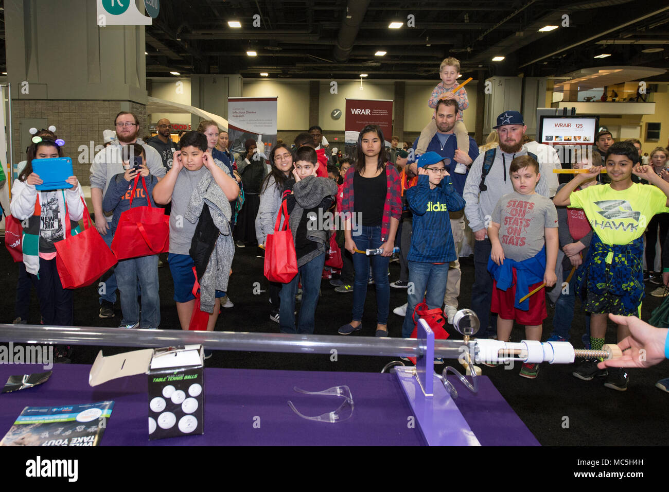 A crowd awaits a ping pong ball to pop during an exhibition at the USA ...