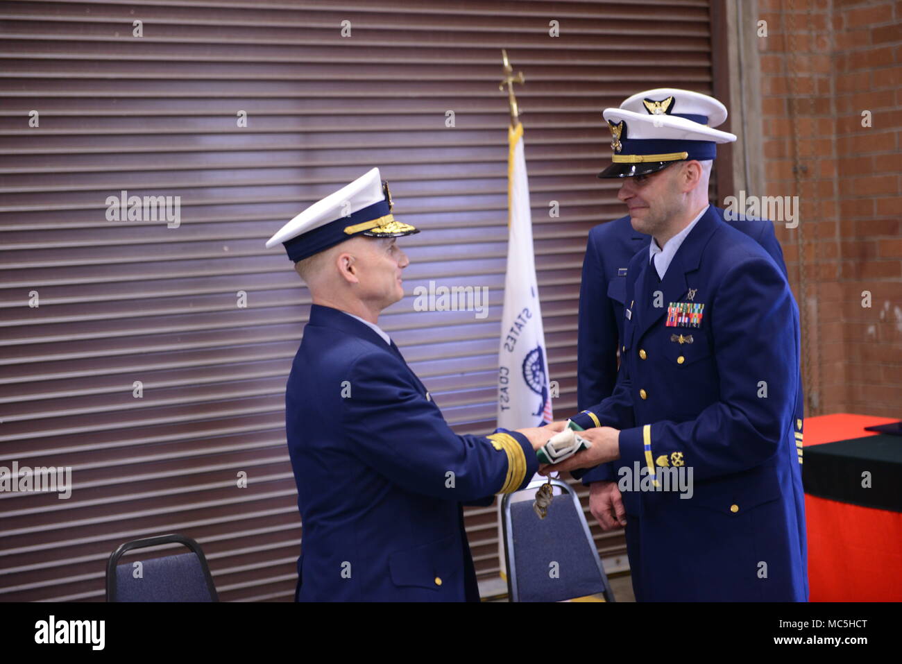 Rear Adm. David Throop, commander, Coast Guard 13th District, presents ...