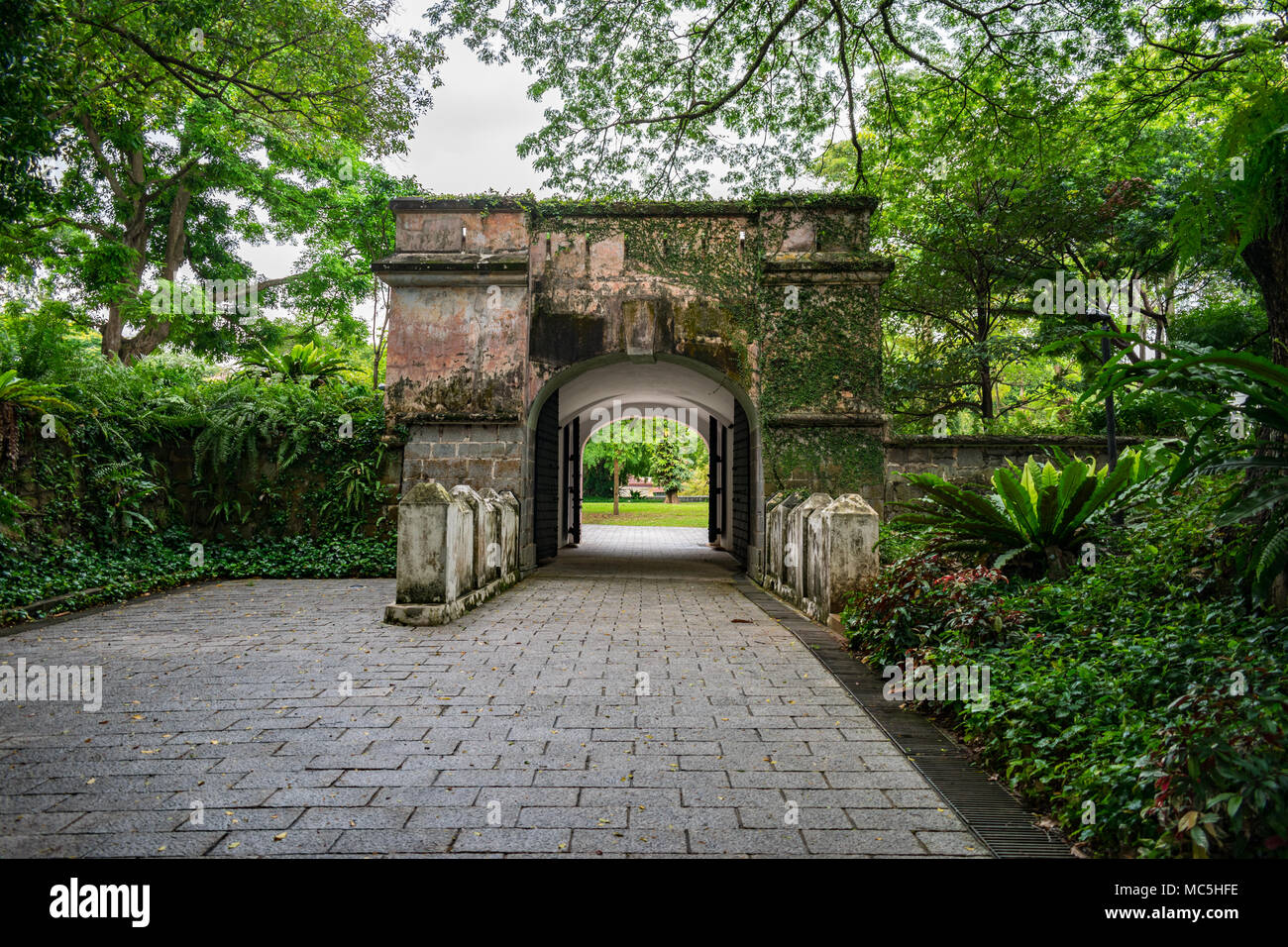 The facade entrance of the Fort Gate surrounded by forest at Fort ...