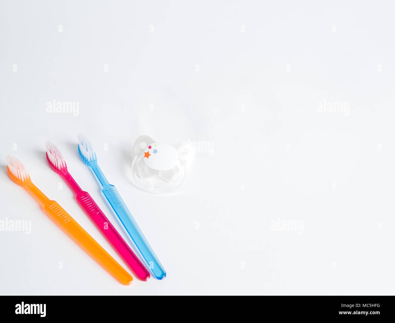 The toothbrushes and pacifier are next to each other Stock Photo - Alamy