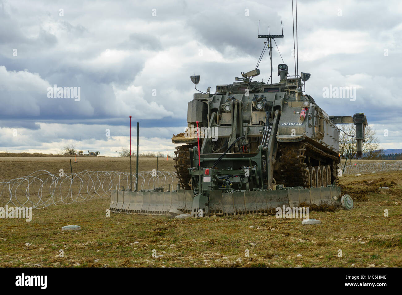 A U.K. Terrier armored digger clears a minefield and prepares to breach ...