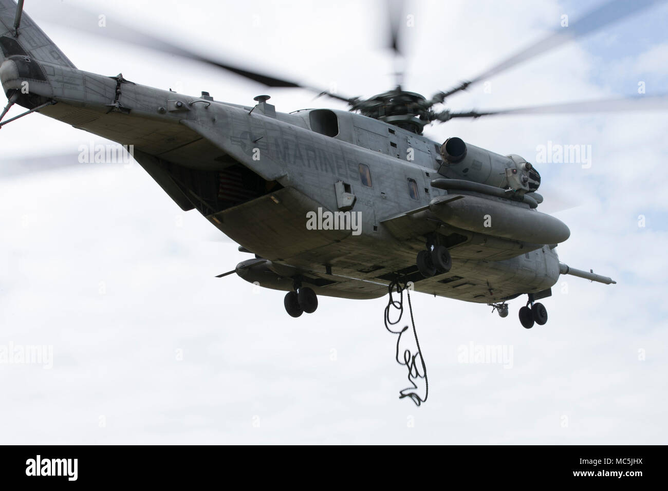 A rope used for fast roping gets released from a CH-53E Super Stallion ...
