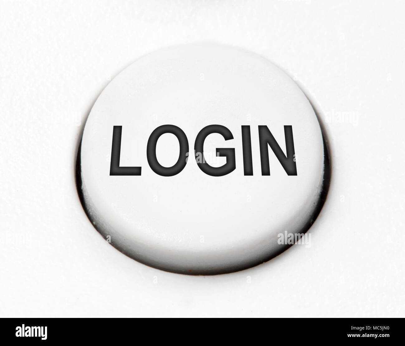 A white round button switch - log in, close up. Control mechanical key ...