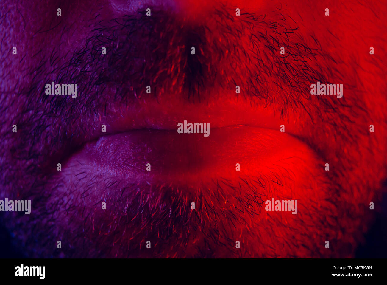 Macro close up on man mouth with serious facial expression. Portrait of ...