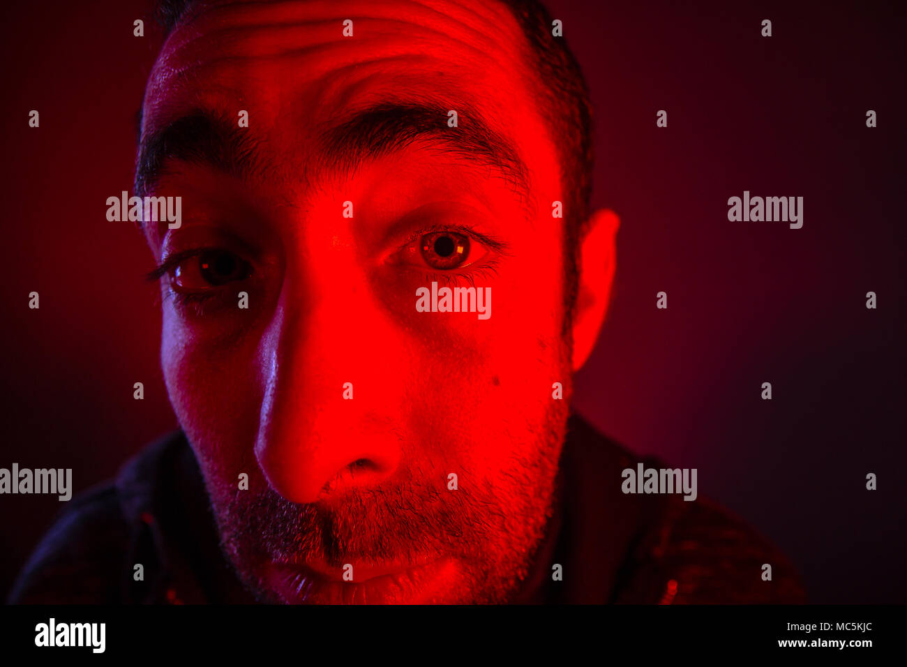 Man with suspicious facial expression. Close up portrait of doubt or ...