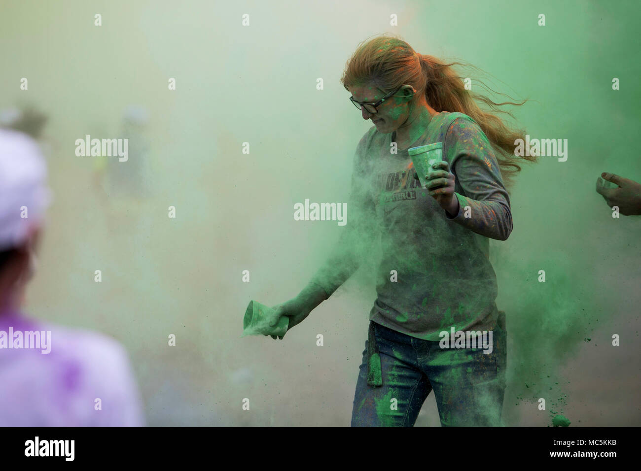 CAMP FOSTER, OKINAWA, Japan – A volunteer flings colored chalk during ...