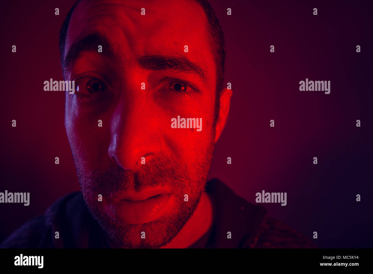 Man raises an eyebrow with shocked facial expression. Close up headshot ...