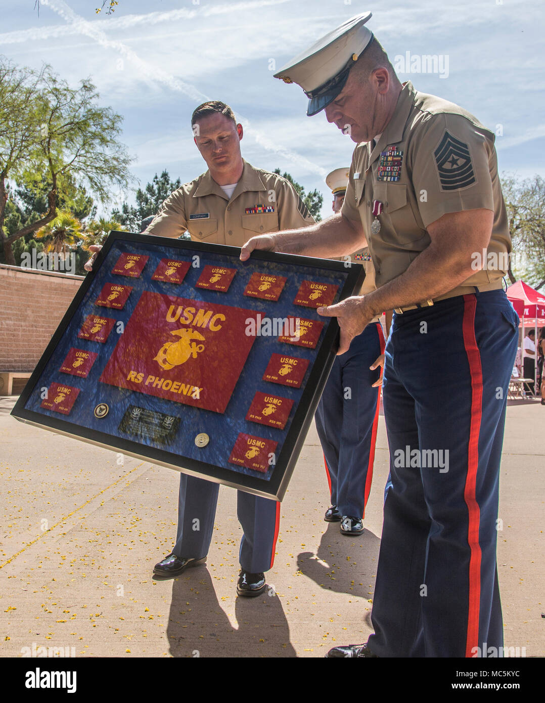 Sergeant Major Amman E. Catalan is awarded a momento by the Marine ...