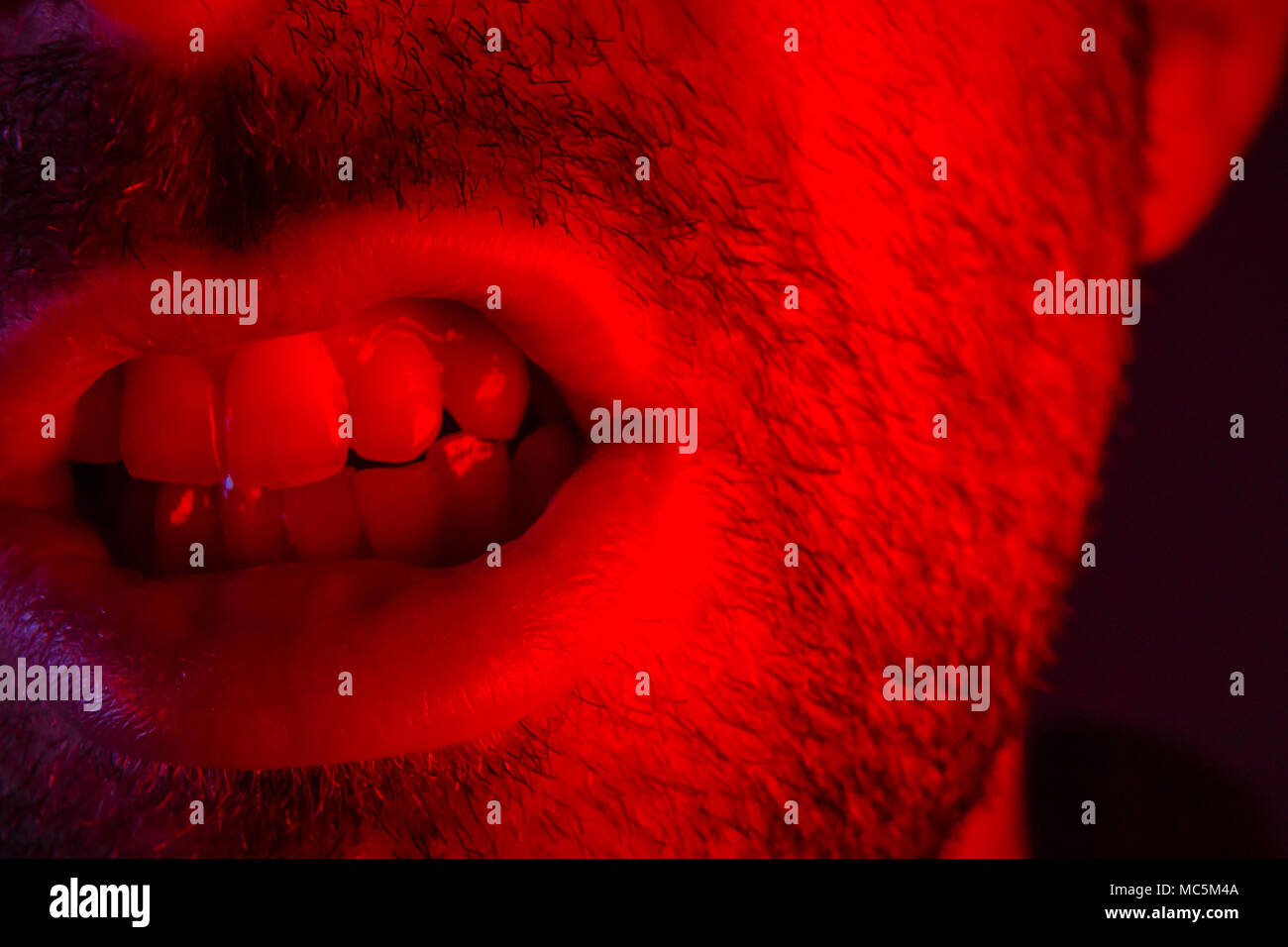 Man with angry facial expression. Macro close up portrait of a man with ...