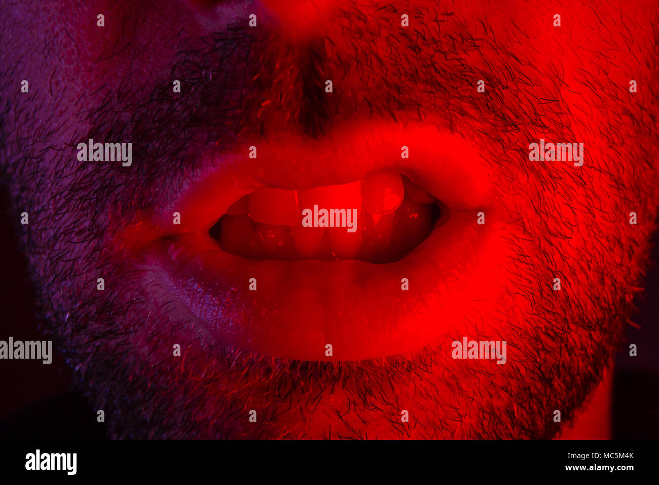 Man with angry facial expression. Macro close up portrait of a man with ...