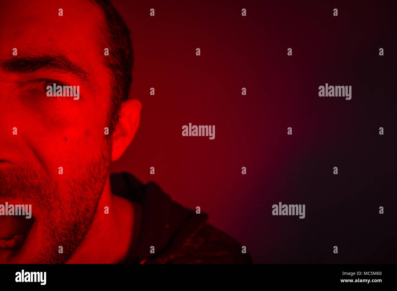 Man with angry facial expression screaming out loud. Close up portrait ...