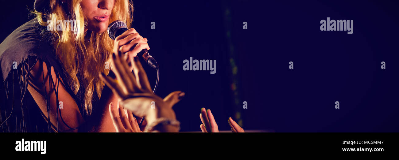Singer performing for audience on stage Stock Photo - Alamy