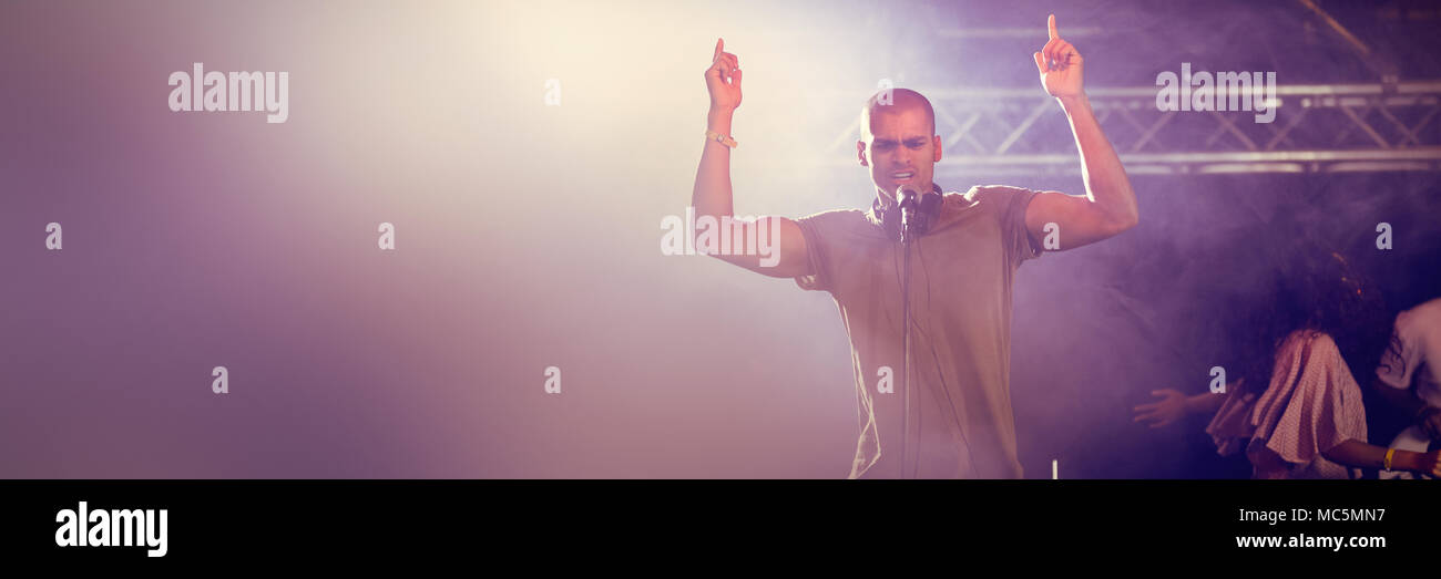 Singer with musicians performing on stage Stock Photo - Alamy