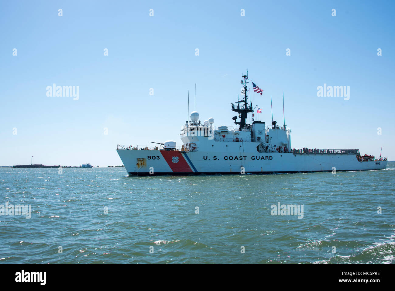 The crew of the Coast Guard Cutter Harriet Lane sails past Fort Sumter ...