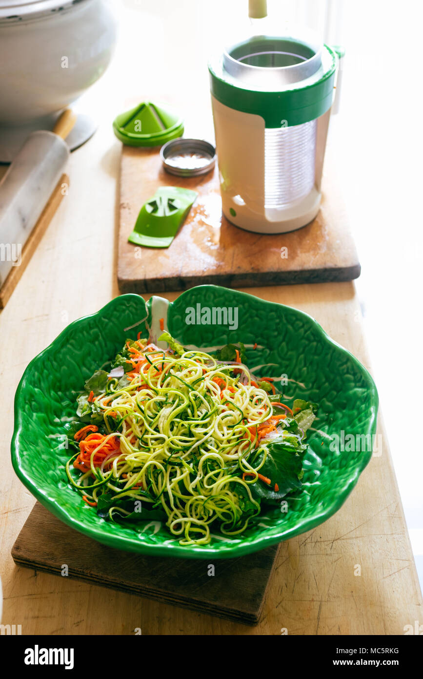Vegetables sliced julienne for an healthy salad, with a domestic tool ...