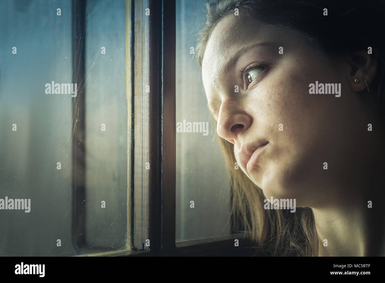 Sad Teenage Girl Looking Out Window