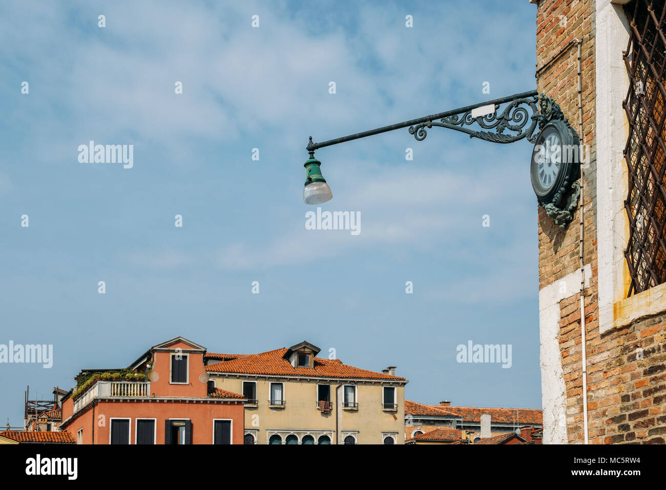 Clock hanging on building hi-res stock photography and images - Alamy