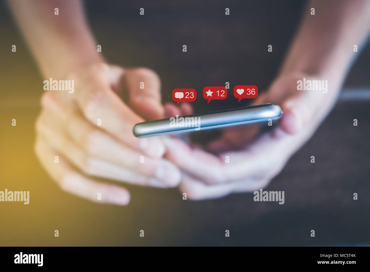 holding mobile phone with notification symbols - girl uses smartphone ...