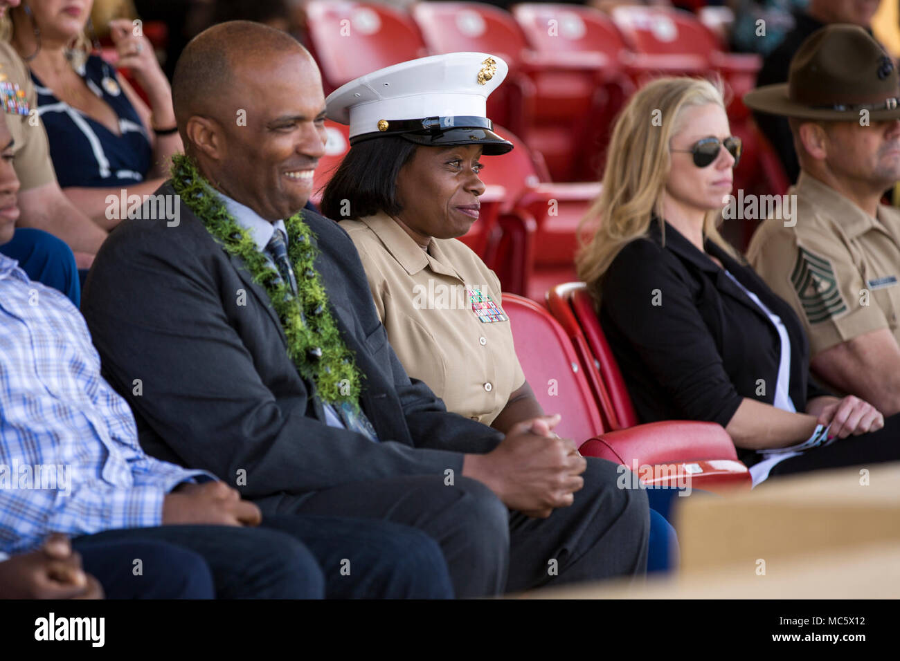 Family members and loved ones sit in a reviewing stand during the ...