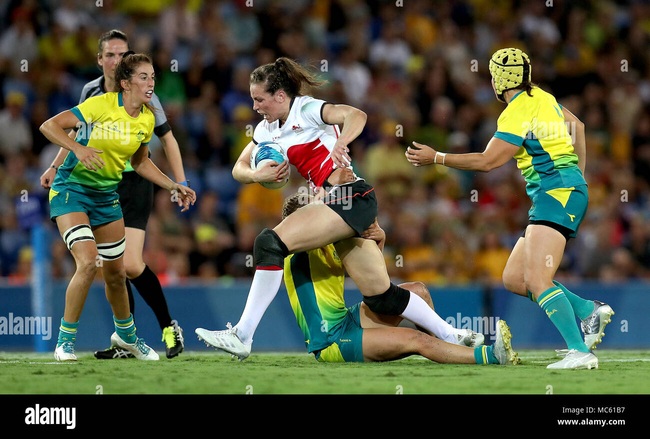 Emily Scarratt (centre) is tackled by Australia's Emma Sykes during the ...