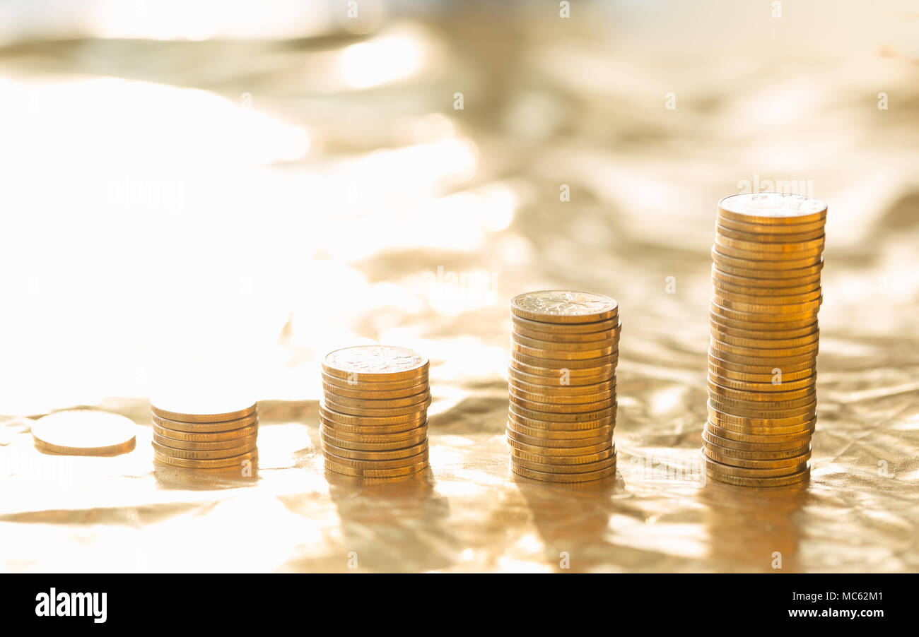 Gold coin with stepped growth Stock Photo - Alamy