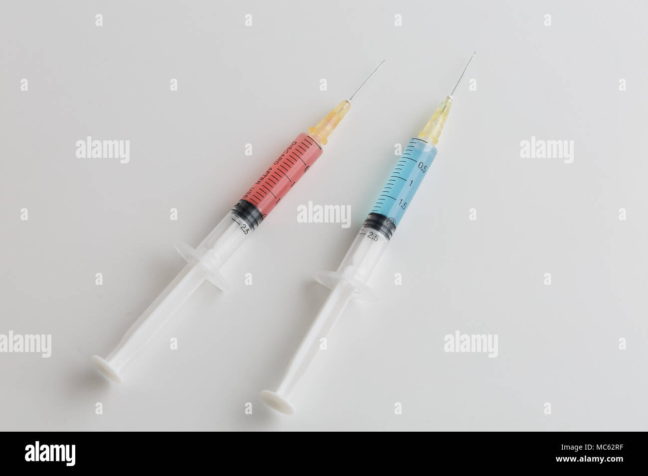 Two syringes on a white background Stock Photo - Alamy