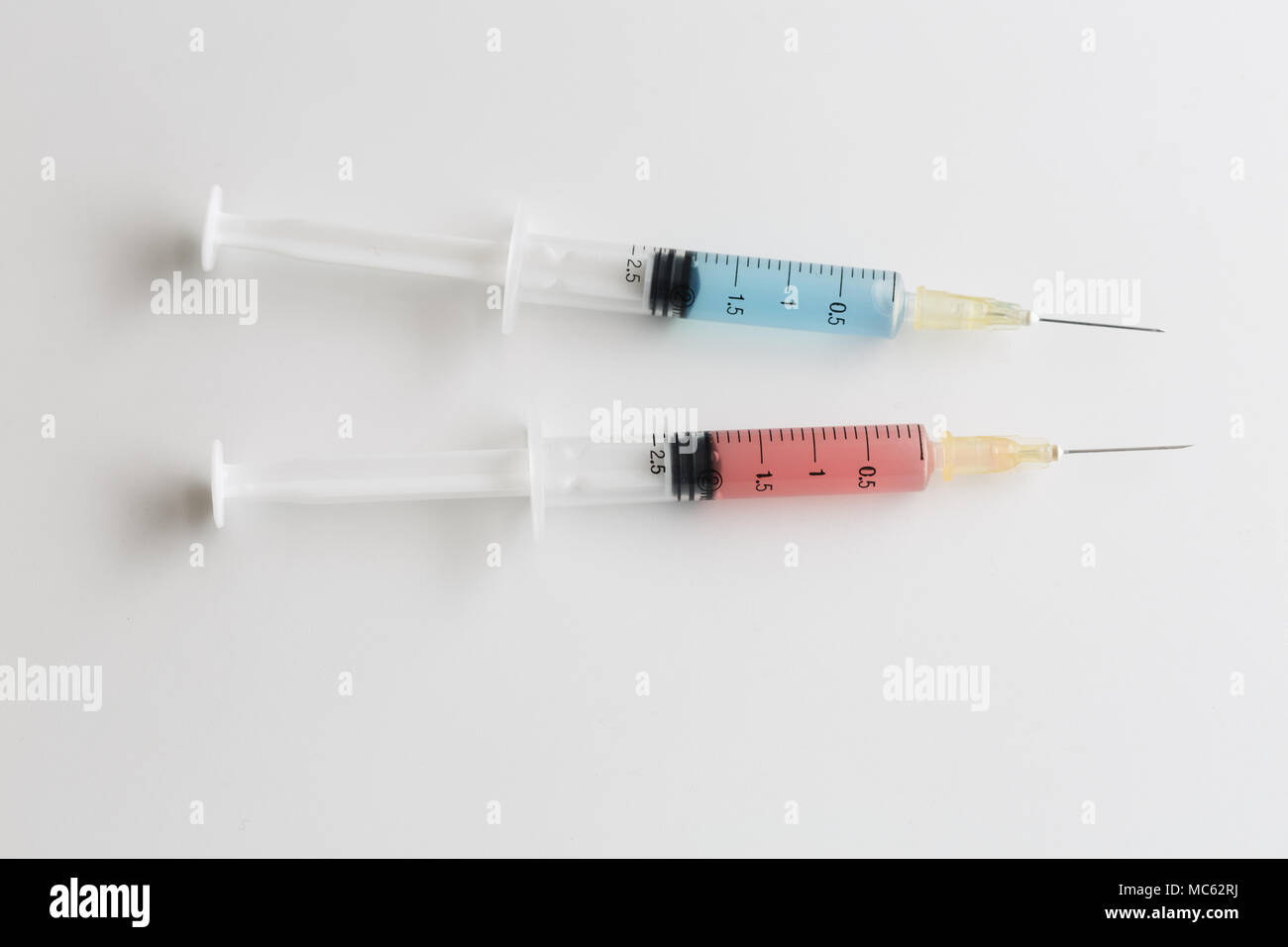 Two syringes on a white background Stock Photo - Alamy