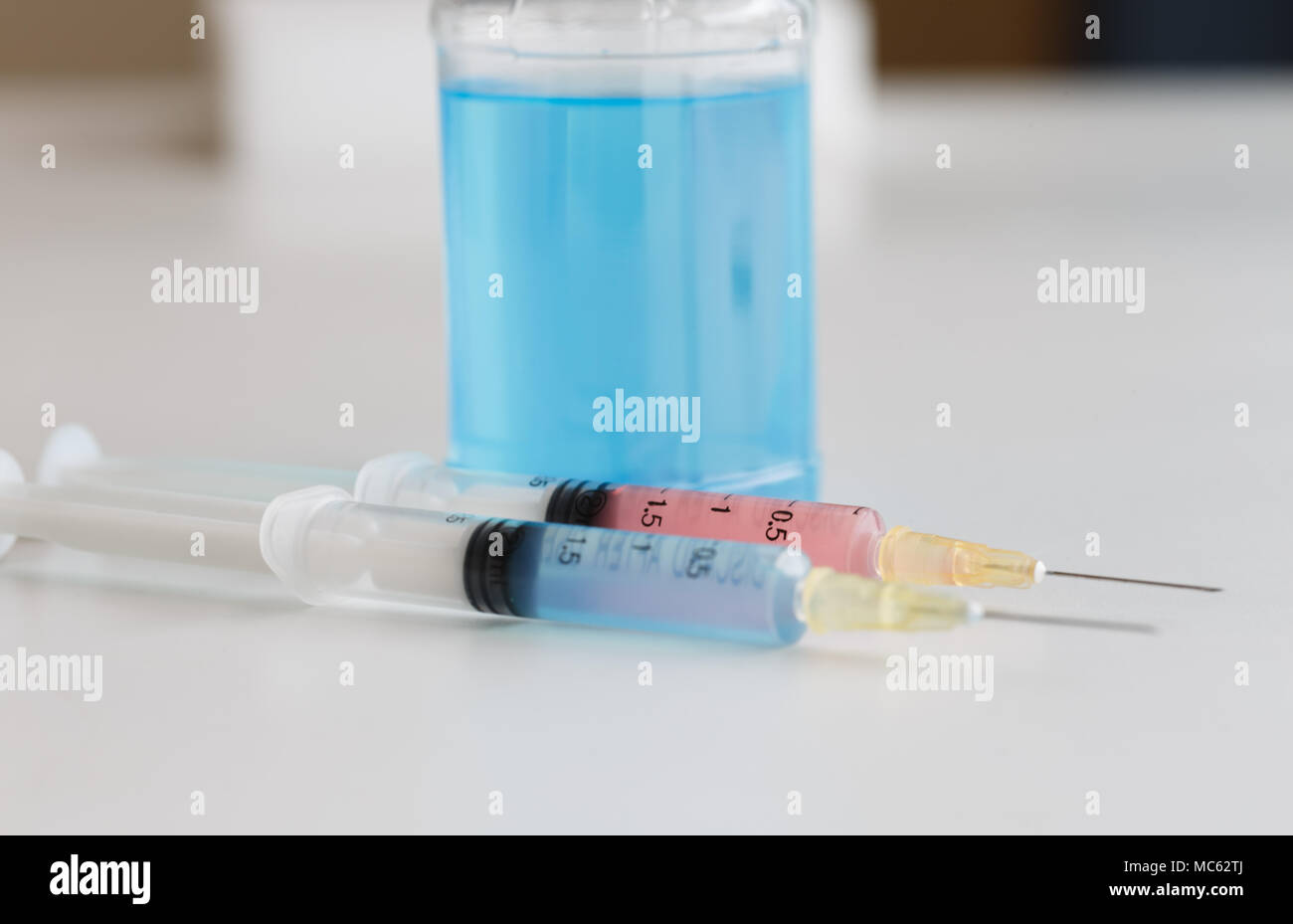 Two syringes on a white background Stock Photo - Alamy