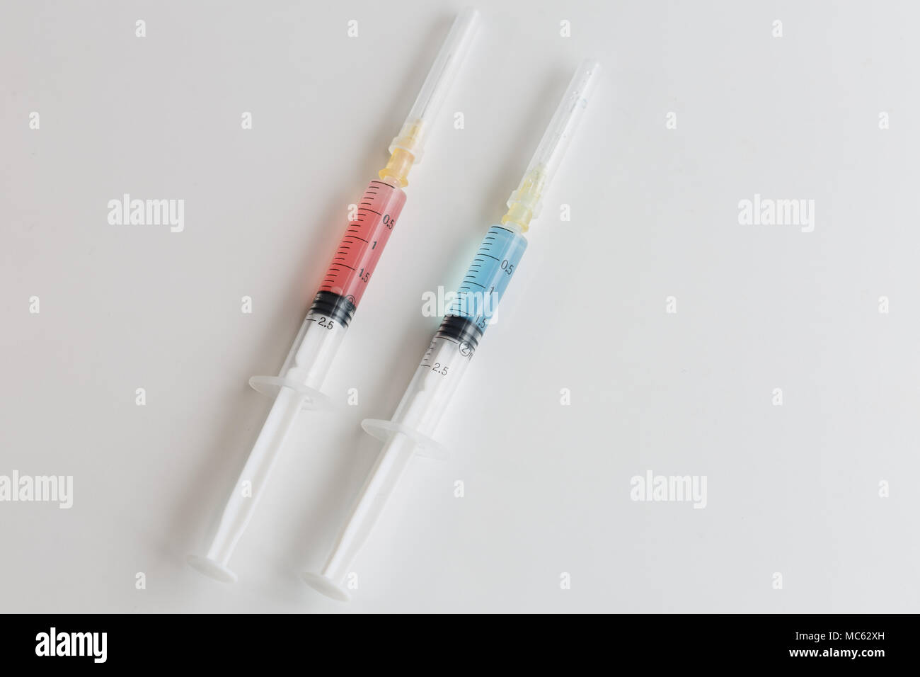 Two syringes on a white background Stock Photo - Alamy
