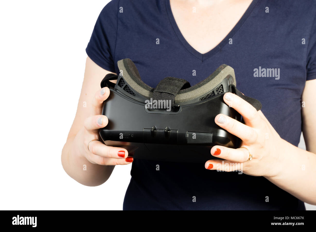 Attractive young woman adjusting her VR headset. Isolated on white ...