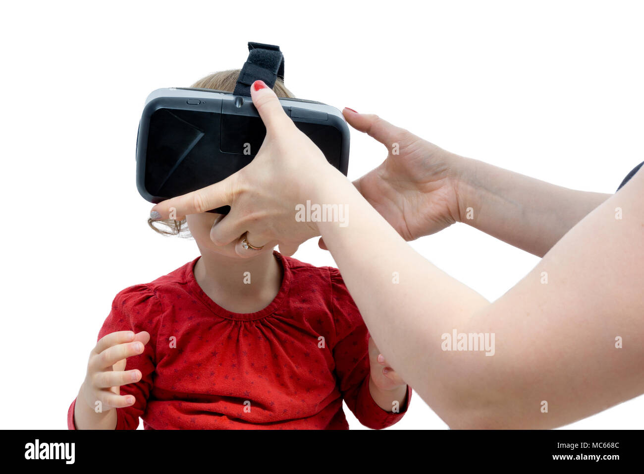 Attractive young woman and daughter adjusting her VR headset. Isolated ...